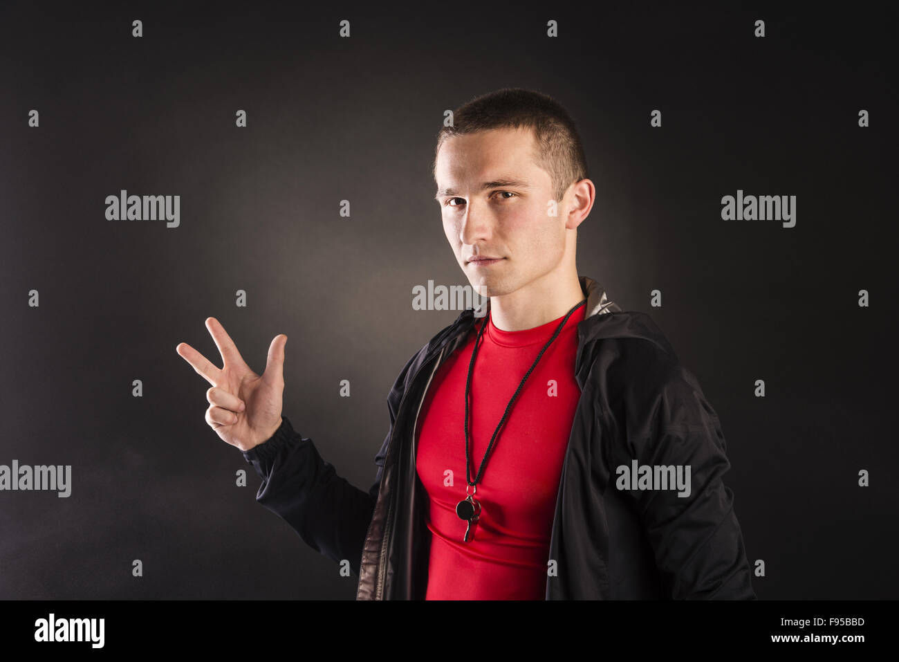 Professional fitness coach isolated on black background Stock Photo - Alamy
