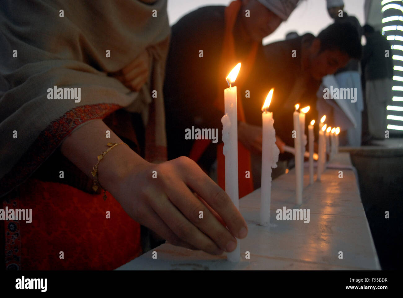 Peshawar, Pakistan. 14th Dec, 2015. Pakistani people light candles ...