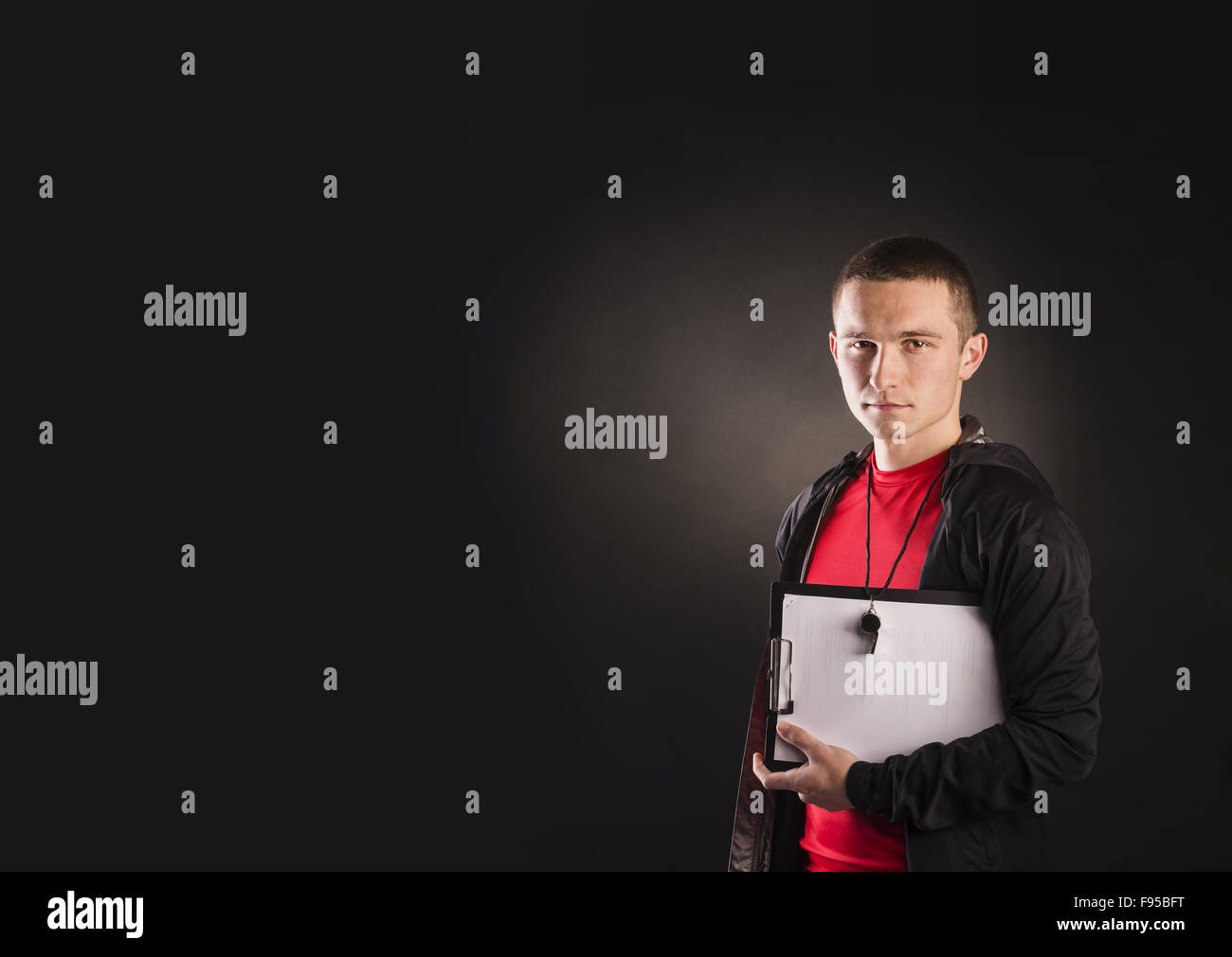 Professional fitness coach isolated on black background Stock Photo - Alamy