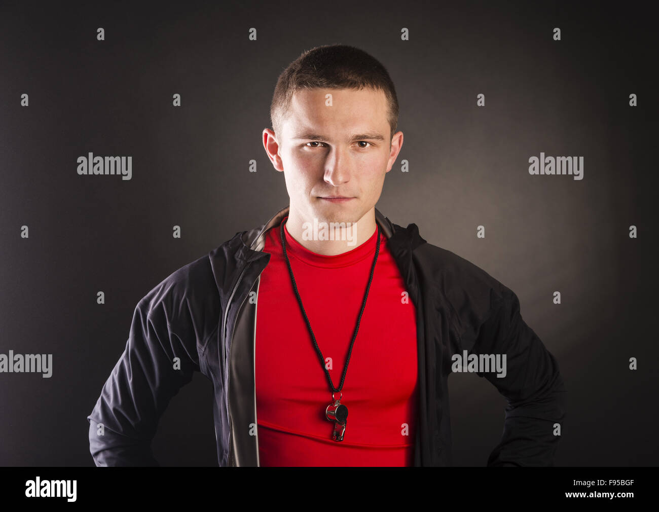 Professional fitness coach isolated on black background Stock Photo - Alamy