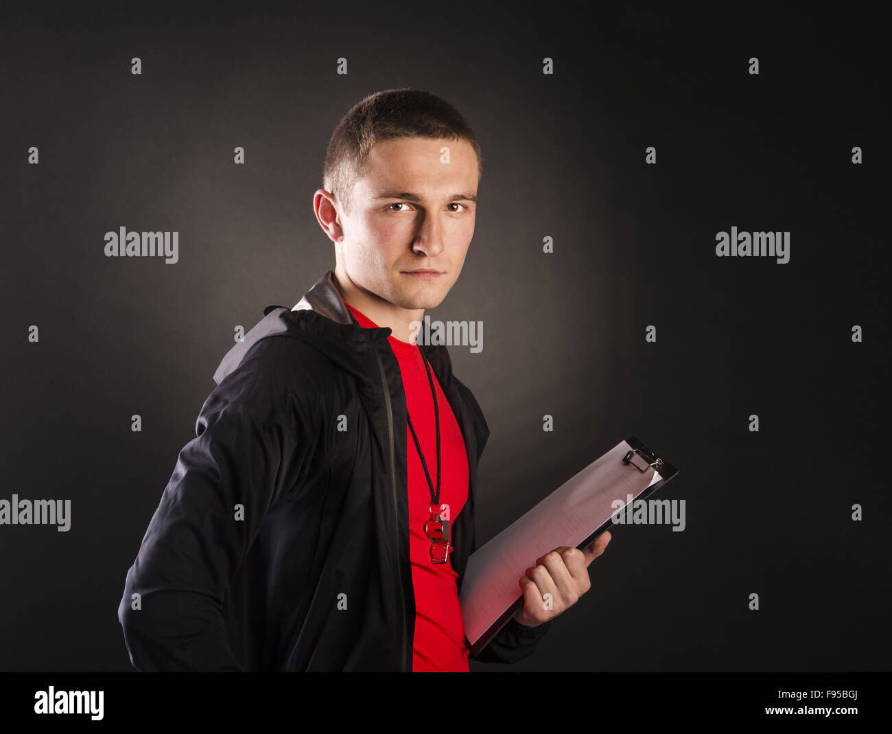 Professional fitness coach isolated on black background Stock Photo - Alamy