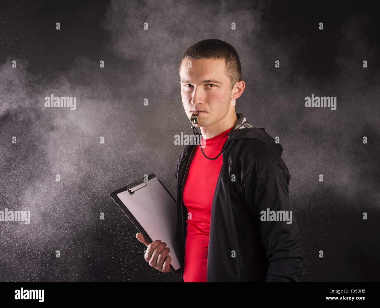 Professional fitness coach isolated on black background Stock Photo - Alamy