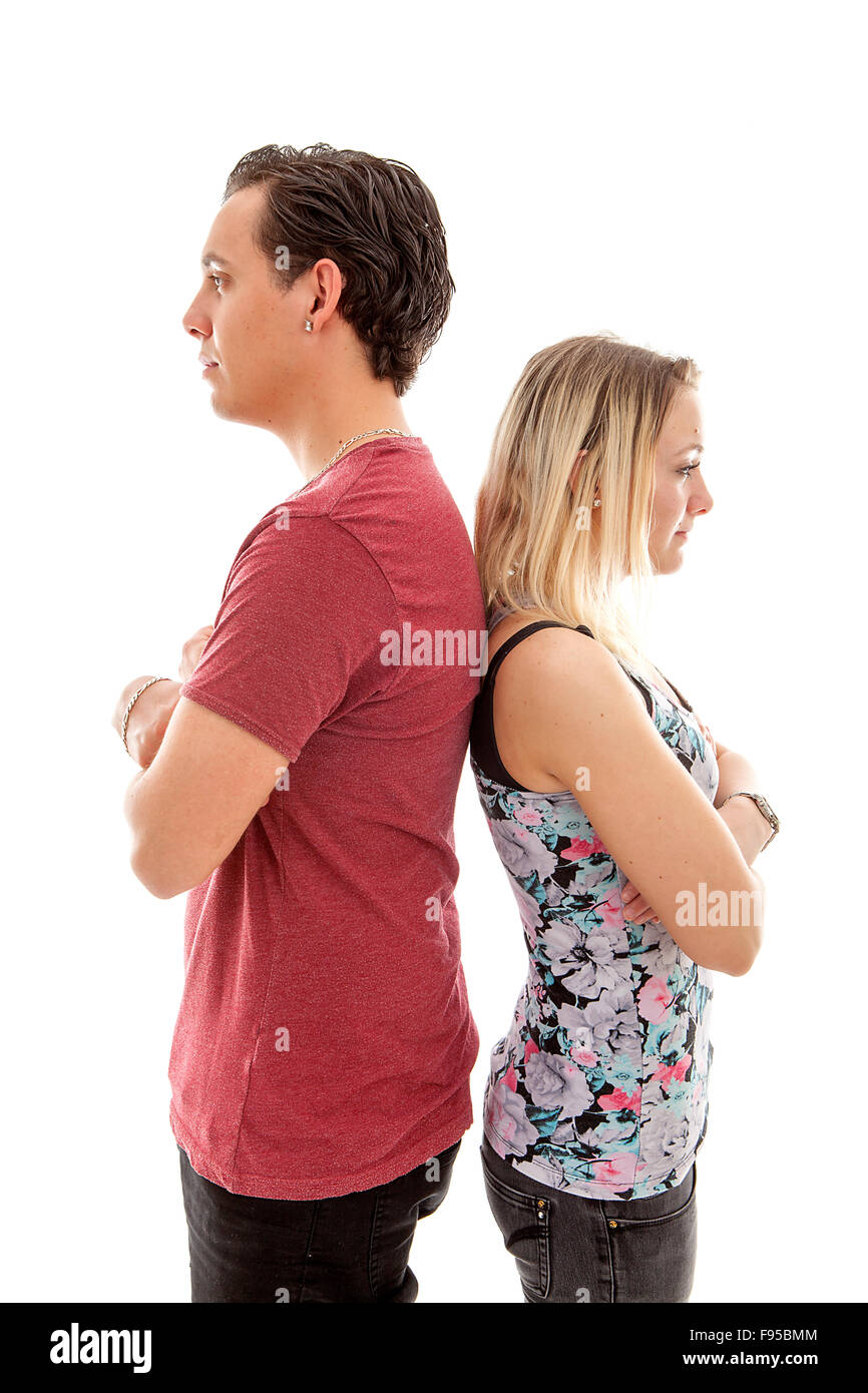 Young couple standing back to back isoalted on white bakground mad at ...