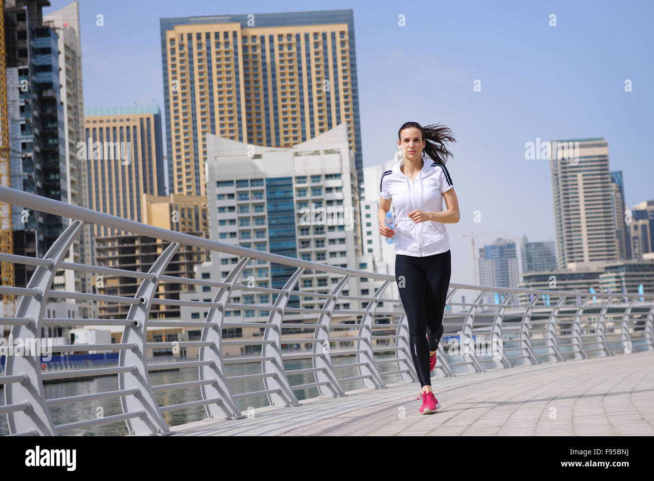 Running in city park. Woman runner outside jogging at morning with ...