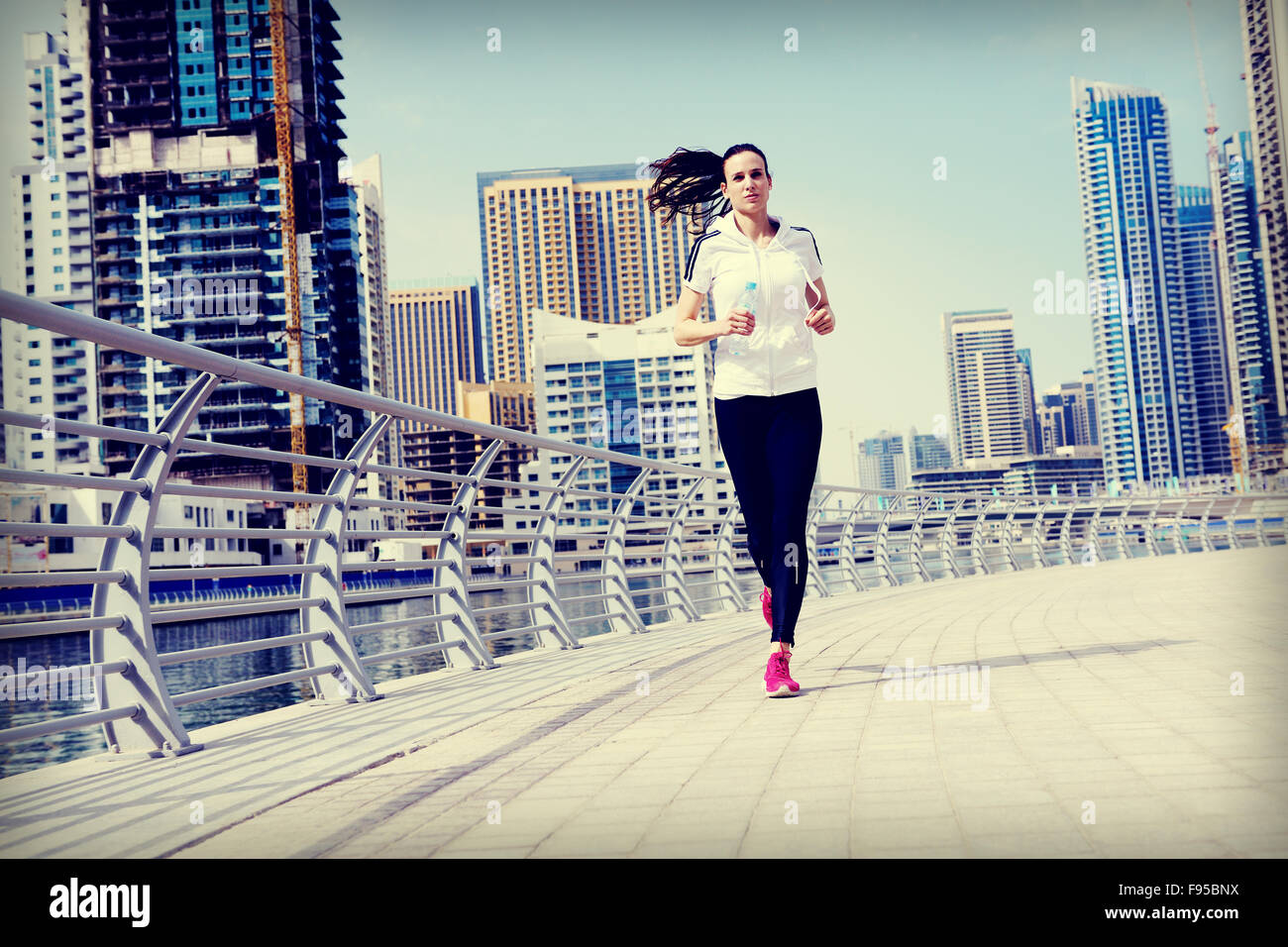 Running in city park. Woman runner outside jogging at morning with ...