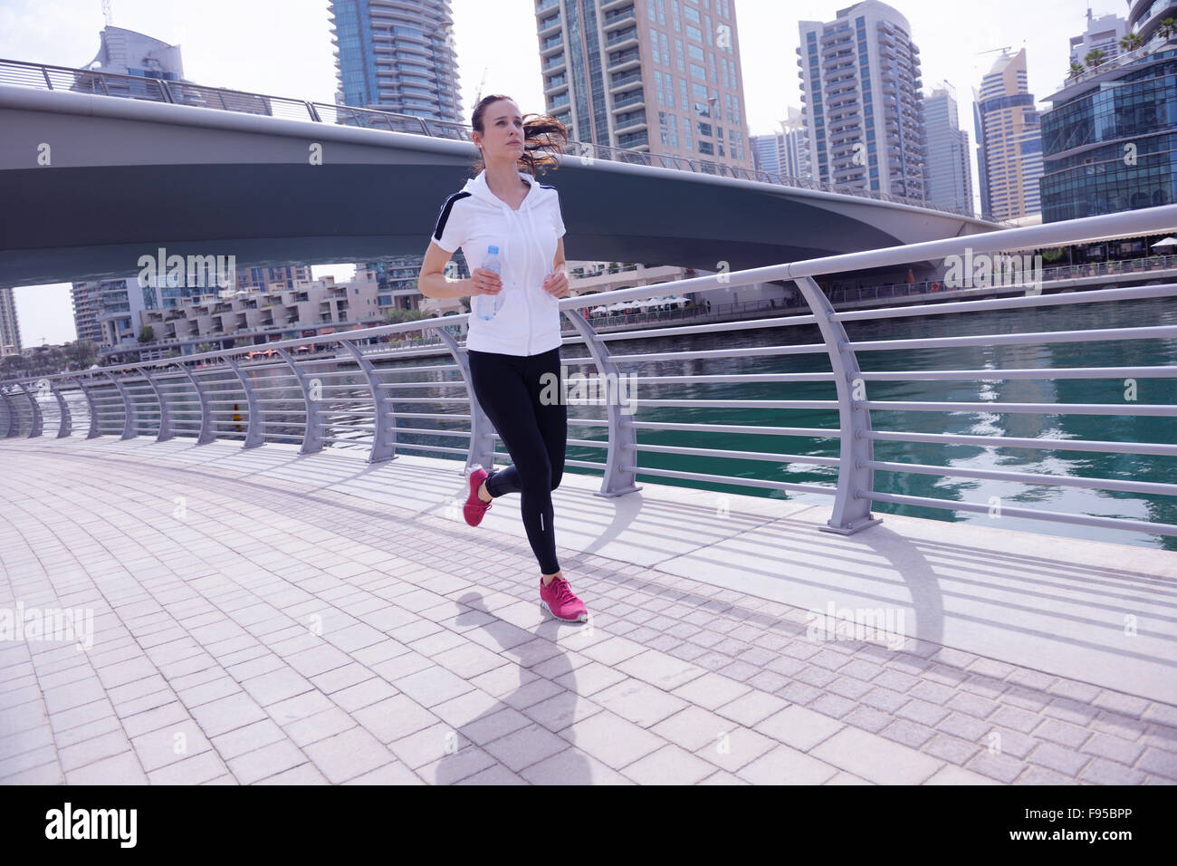 Running in city park. Woman runner outside jogging at morning with ...
