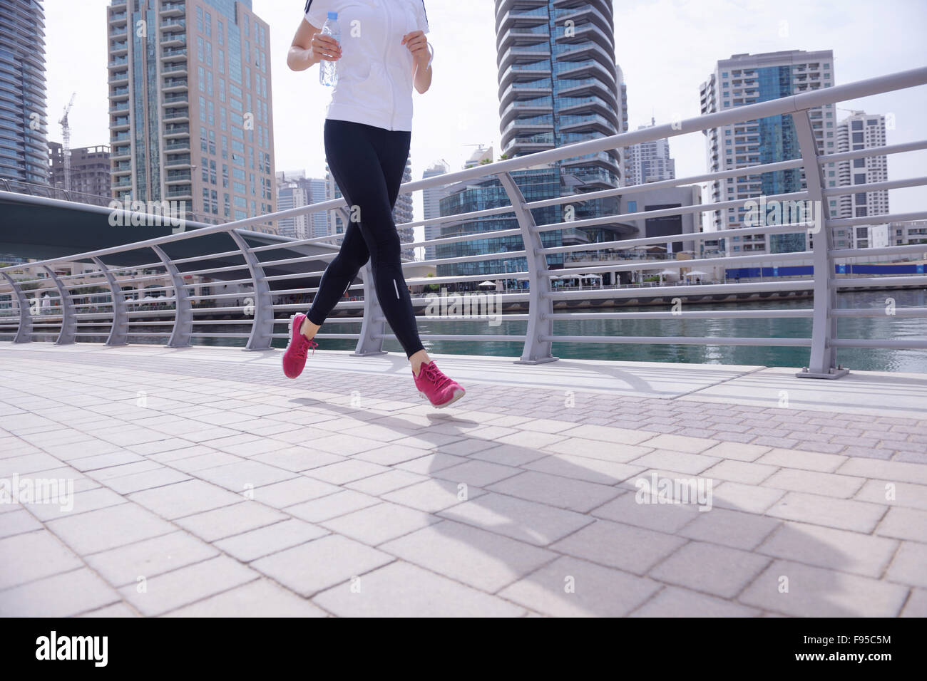Running in city park. Woman runner outside jogging at morning with ...