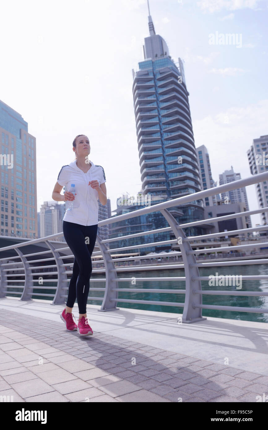 Running in city park. Woman runner outside jogging at morning with ...