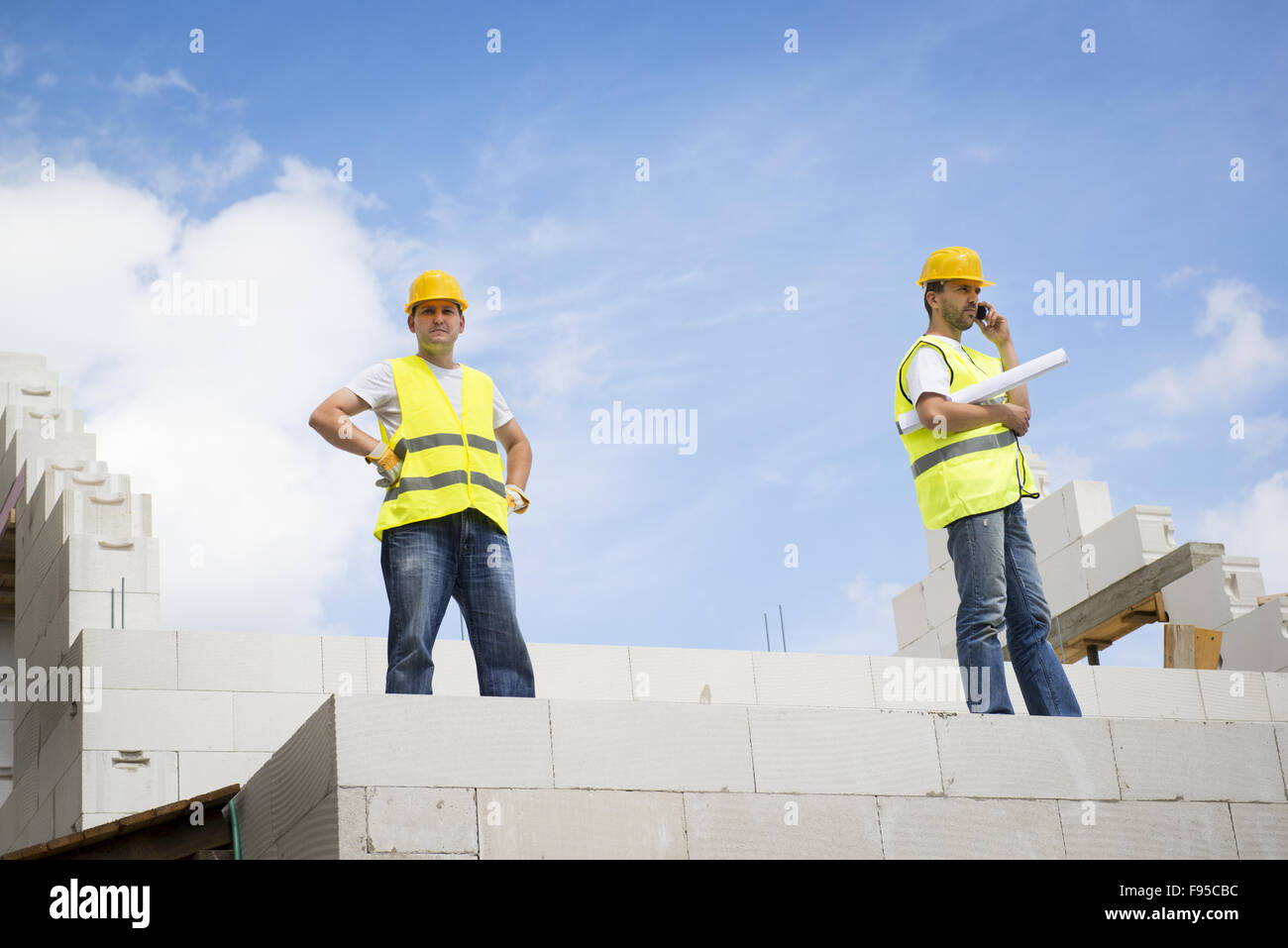 Construction Contractors building a big new home Stock Photo - Alamy