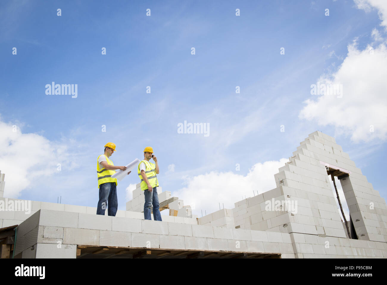 Construction Contractors building a big new home Stock Photo - Alamy