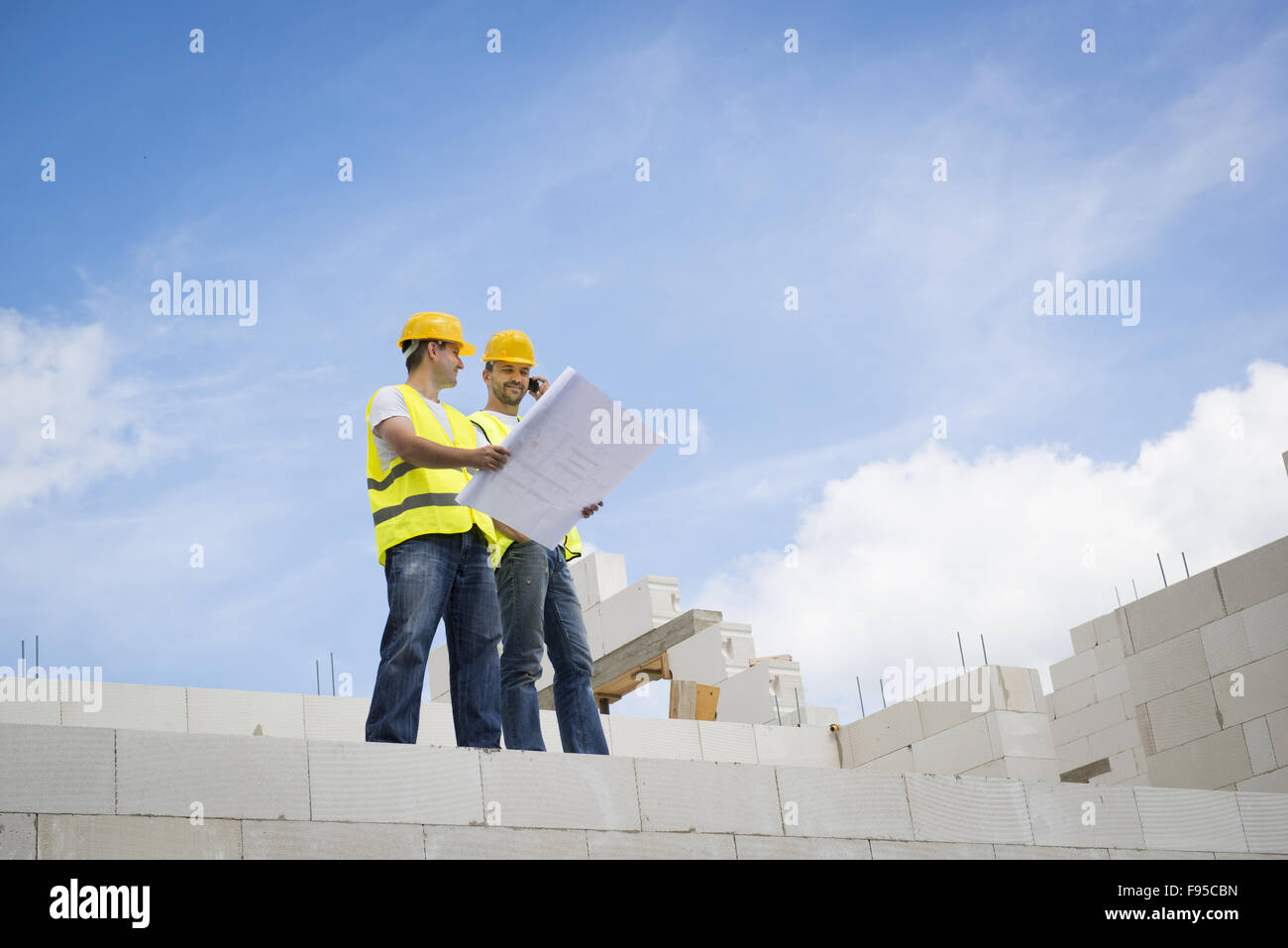 Construction Contractors building a big new home Stock Photo - Alamy
