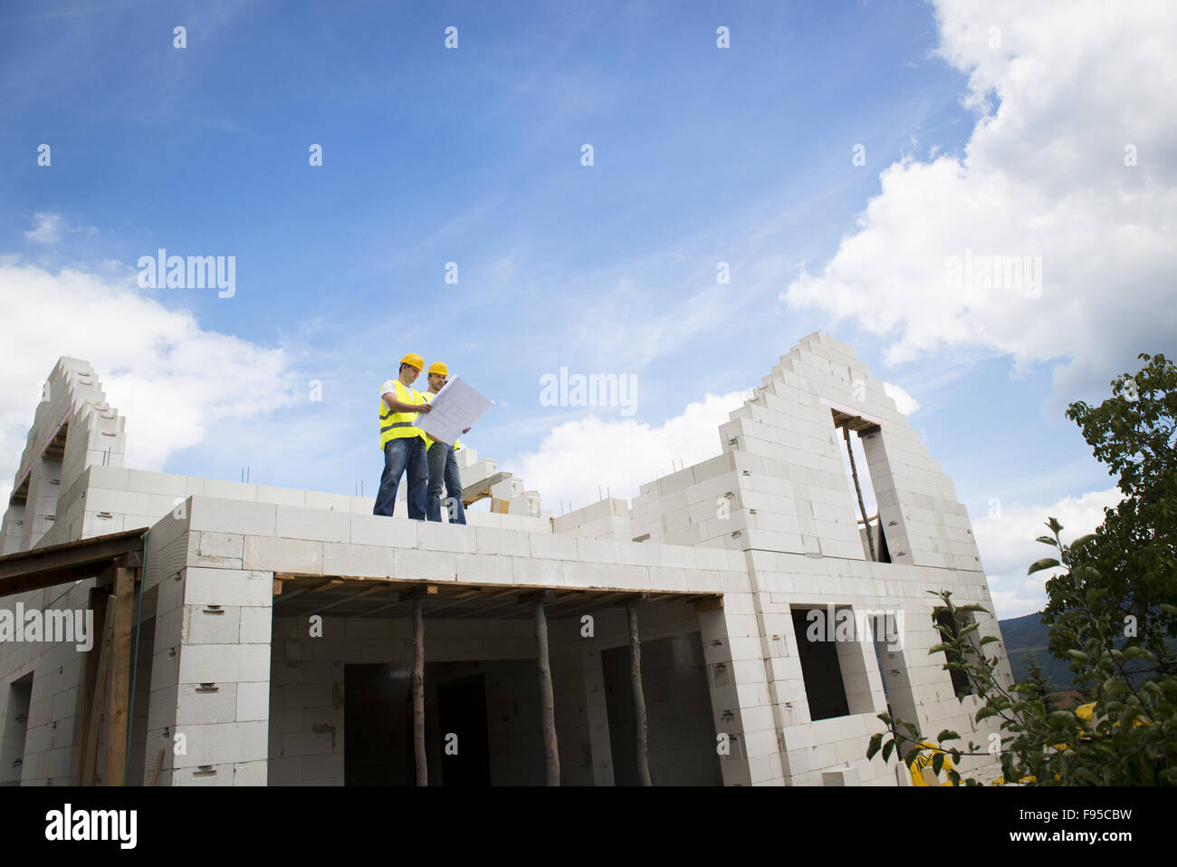 Construction Contractors building a big new home Stock Photo - Alamy