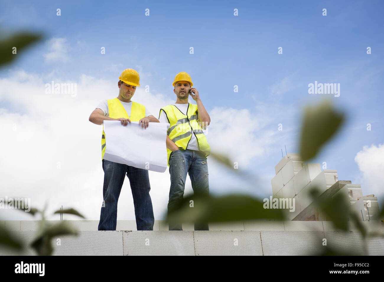 Construction Contractors building a big new home Stock Photo - Alamy