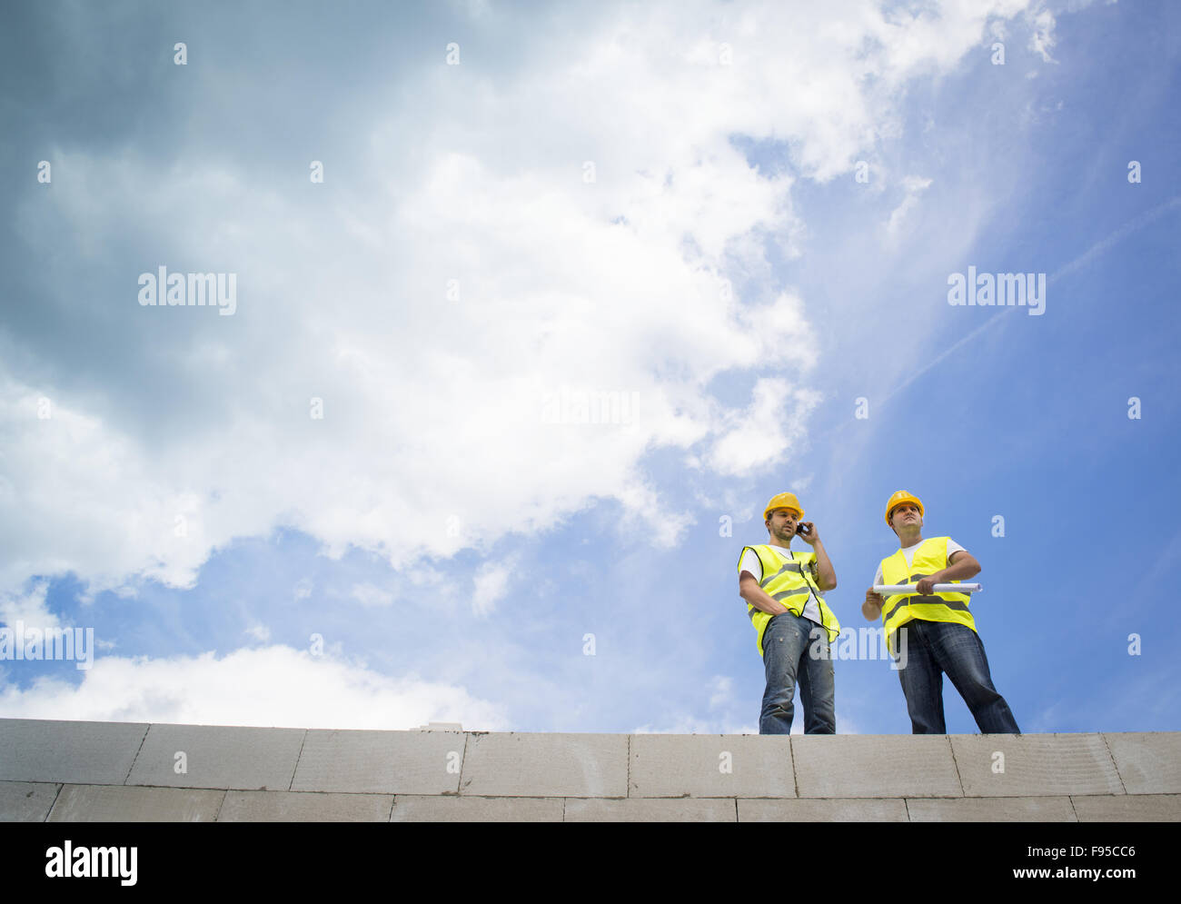 Construction Contractors building a big new home Stock Photo - Alamy