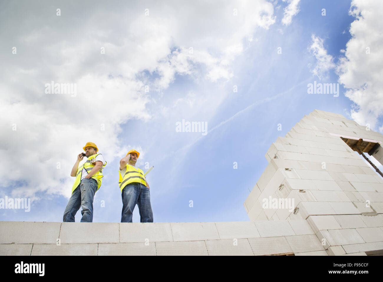 Construction Contractors building a big new home Stock Photo - Alamy