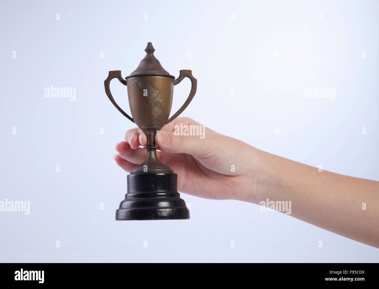 female's hand with little old trophy Stock Photo - Alamy