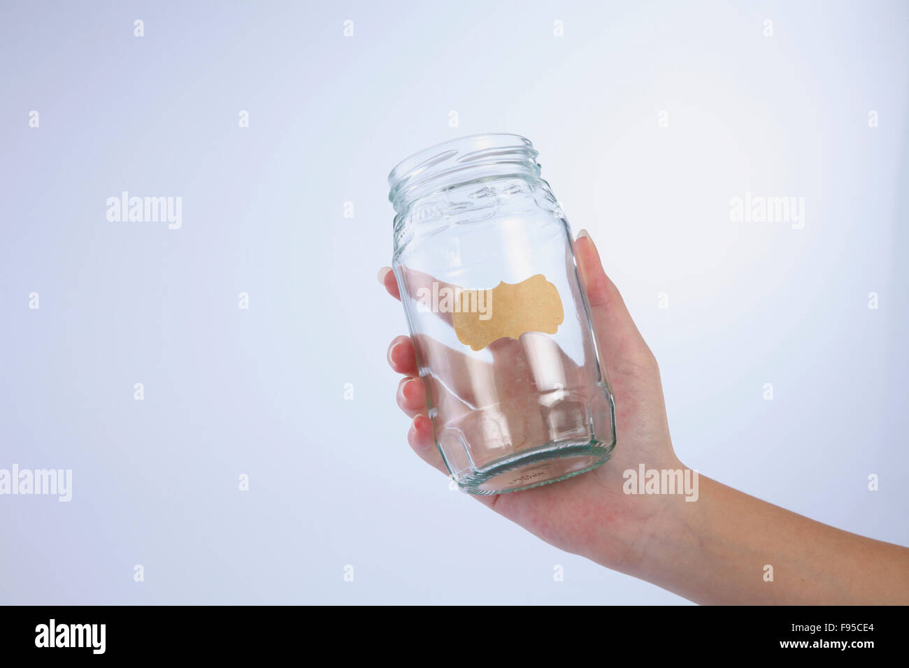 female's hand holding a empty jar Stock Photo - Alamy