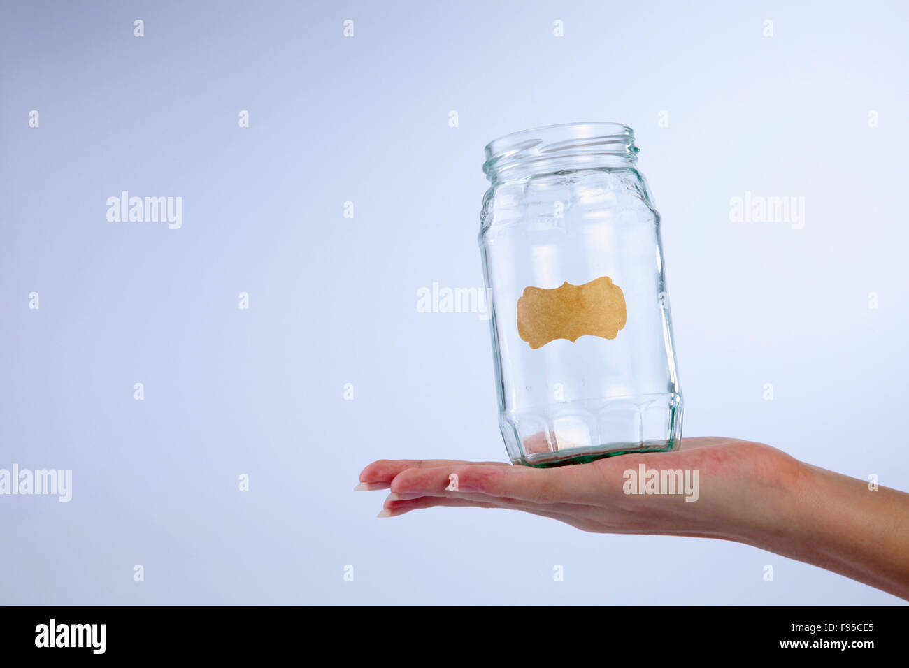 female's hand holding a empty jar Stock Photo - Alamy