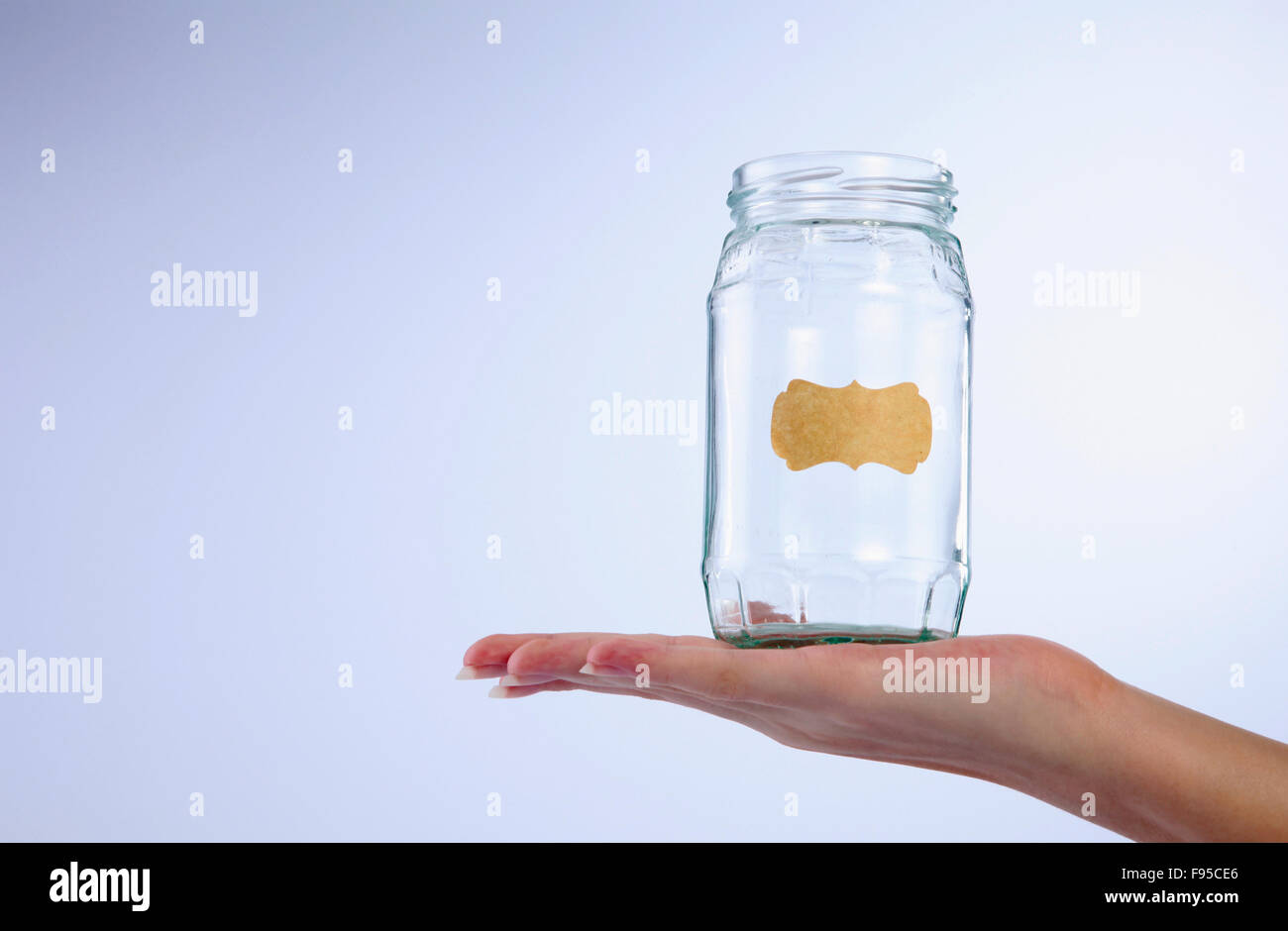 female's hand holding a empty jar Stock Photo - Alamy