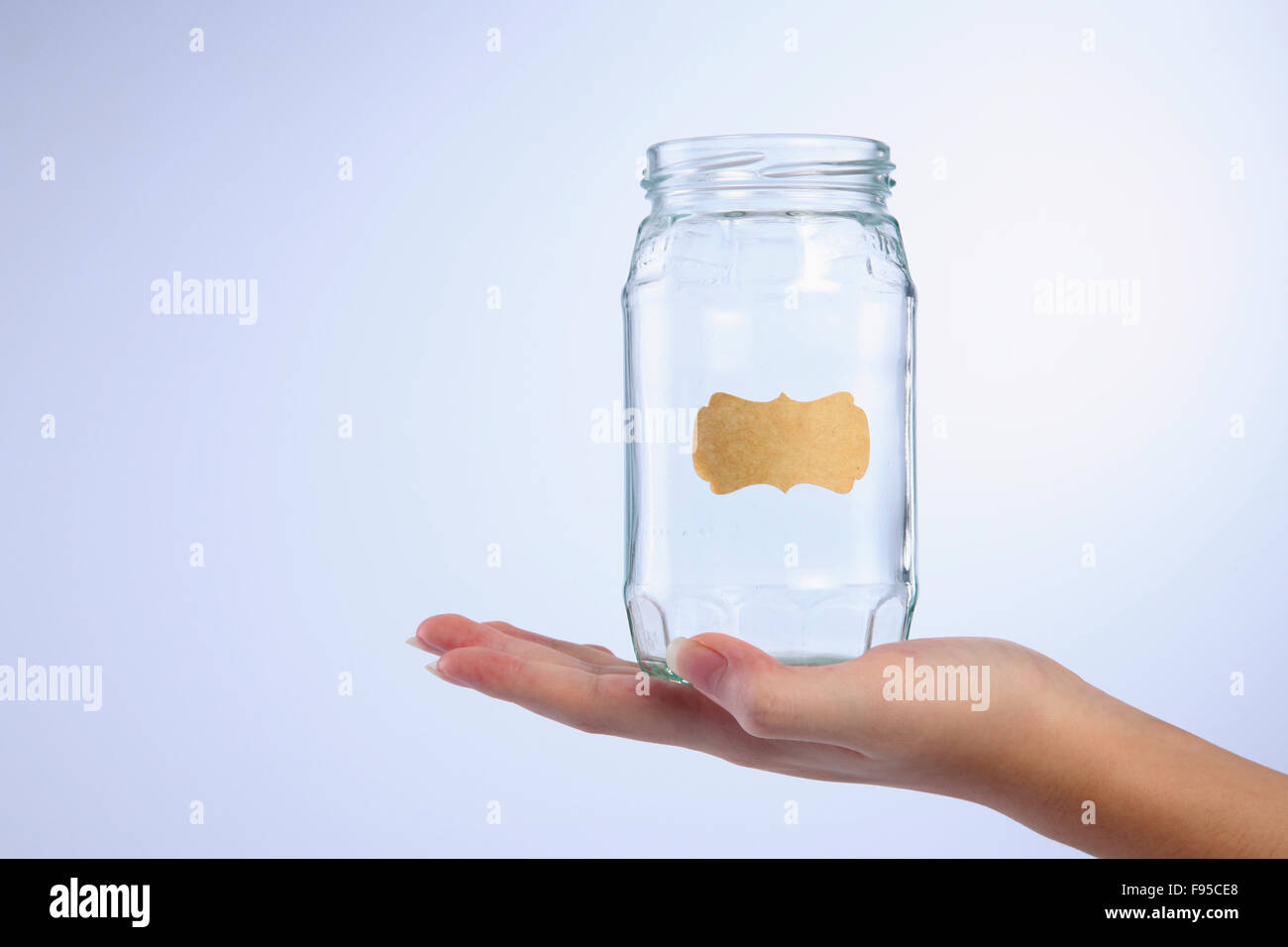 female's hand holding a empty jar Stock Photo - Alamy