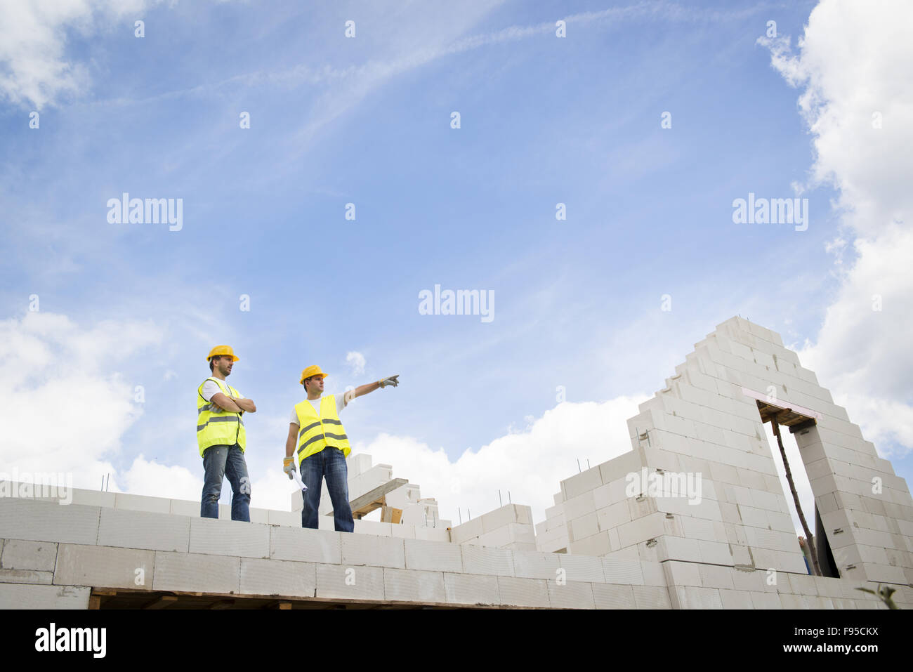 Construction Contractors building a big new home Stock Photo - Alamy