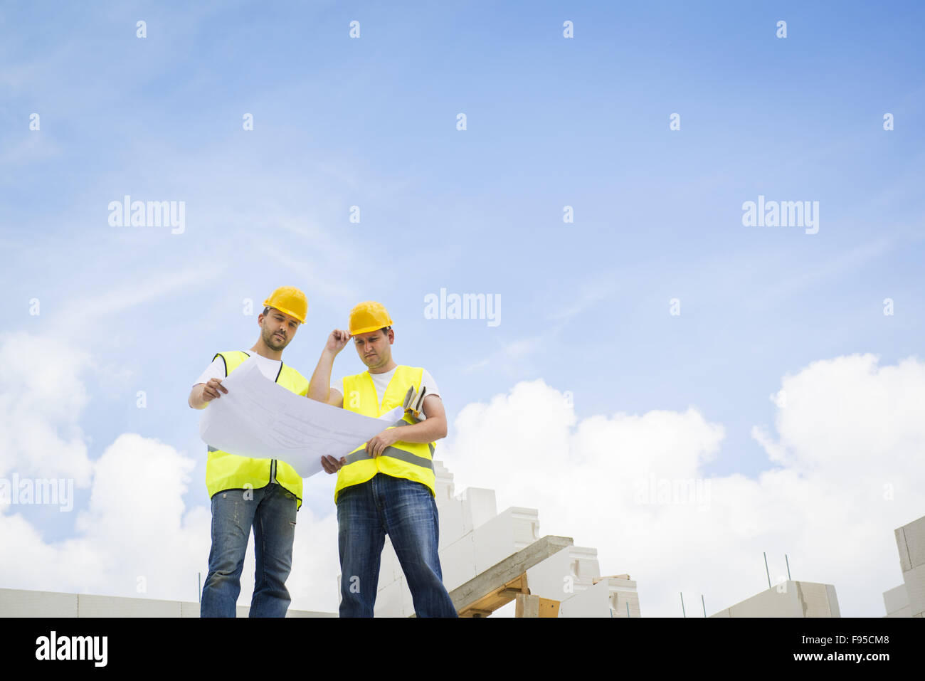 Construction Contractors building a big new home Stock Photo - Alamy