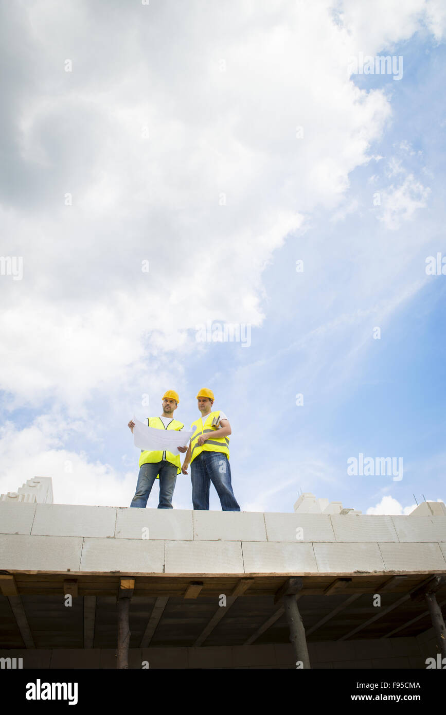 Construction Contractors building a big new home Stock Photo - Alamy