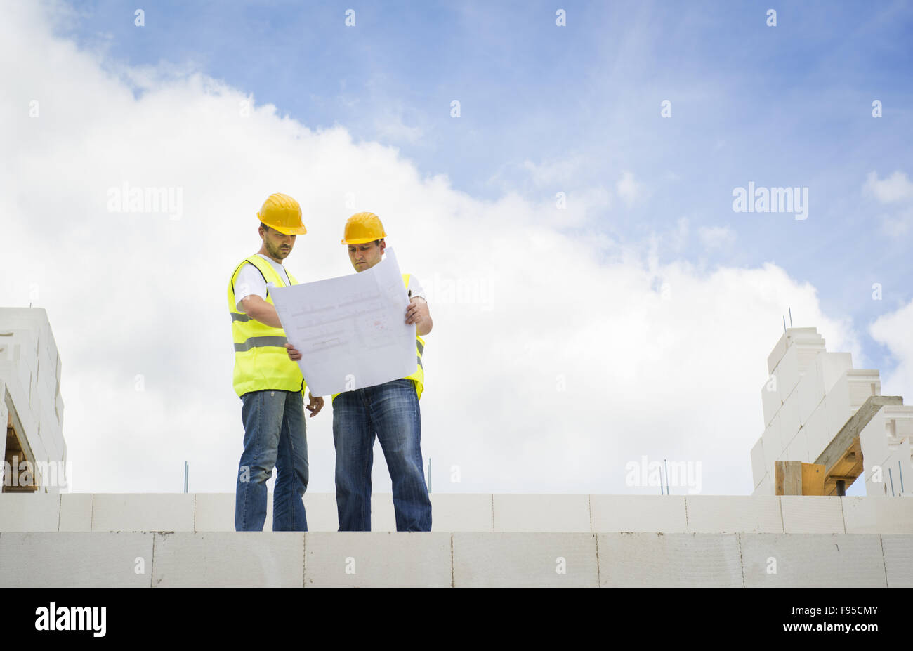 Construction Contractors building a big new home Stock Photo - Alamy