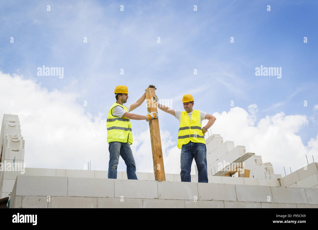 Construction Contractors building a big new home Stock Photo - Alamy
