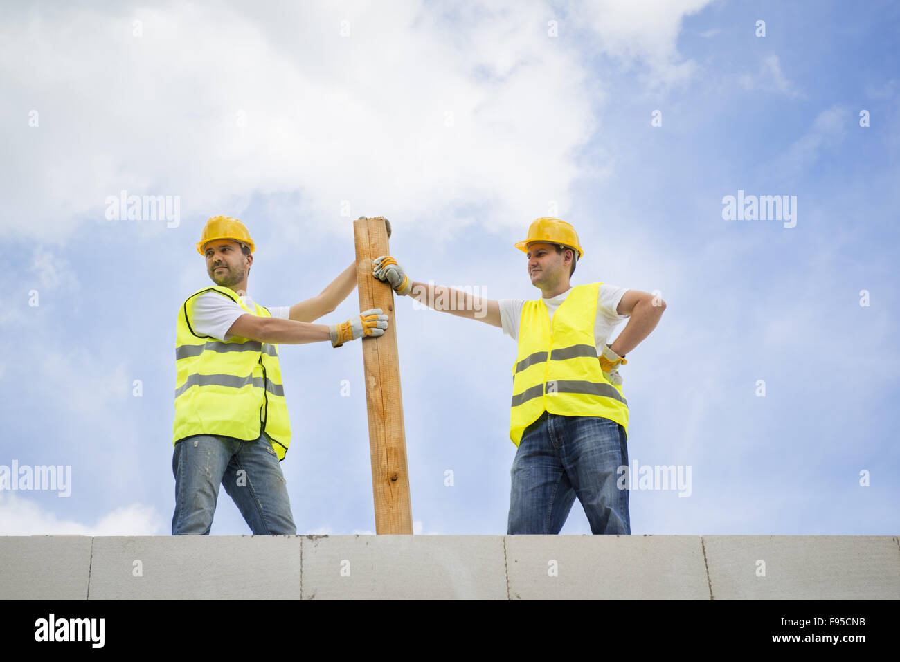 Construction Contractors building a big new home Stock Photo - Alamy