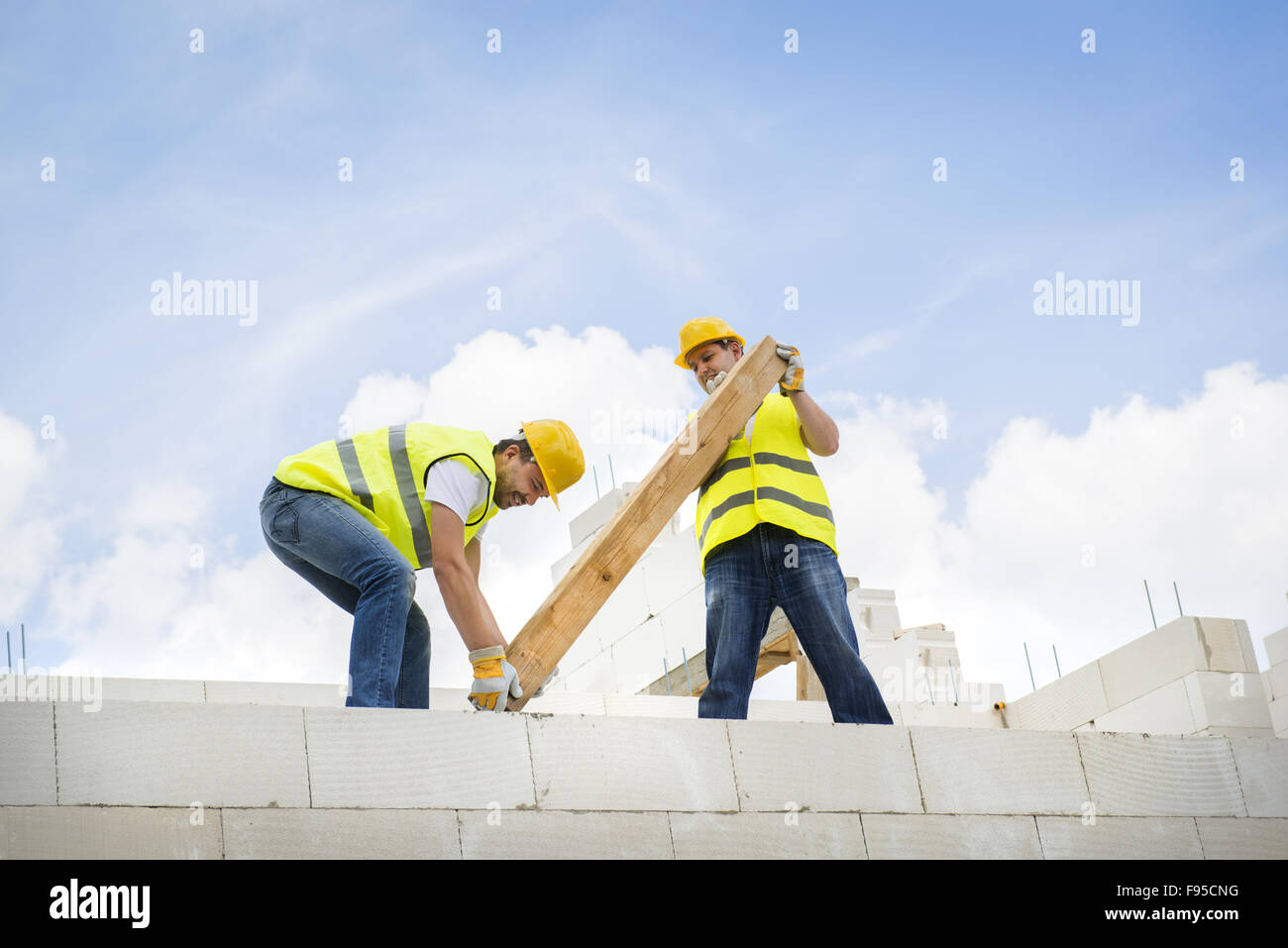 Construction Contractors building a big new home Stock Photo - Alamy