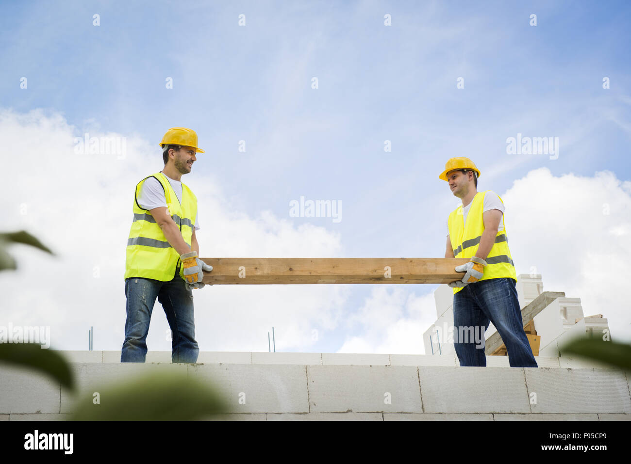 Construction Contractors building a big new home Stock Photo - Alamy