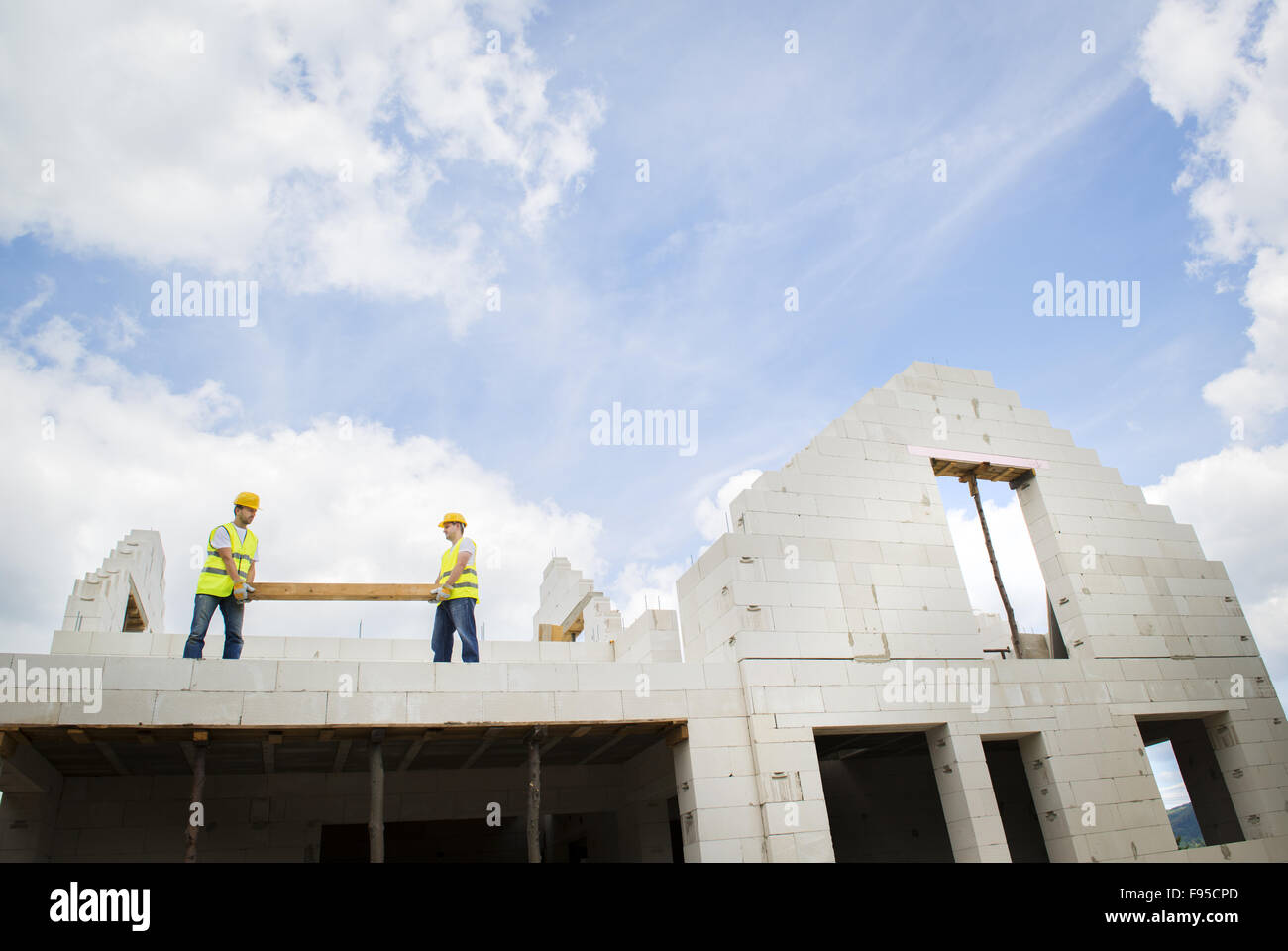 Construction Contractors building a big new home Stock Photo - Alamy