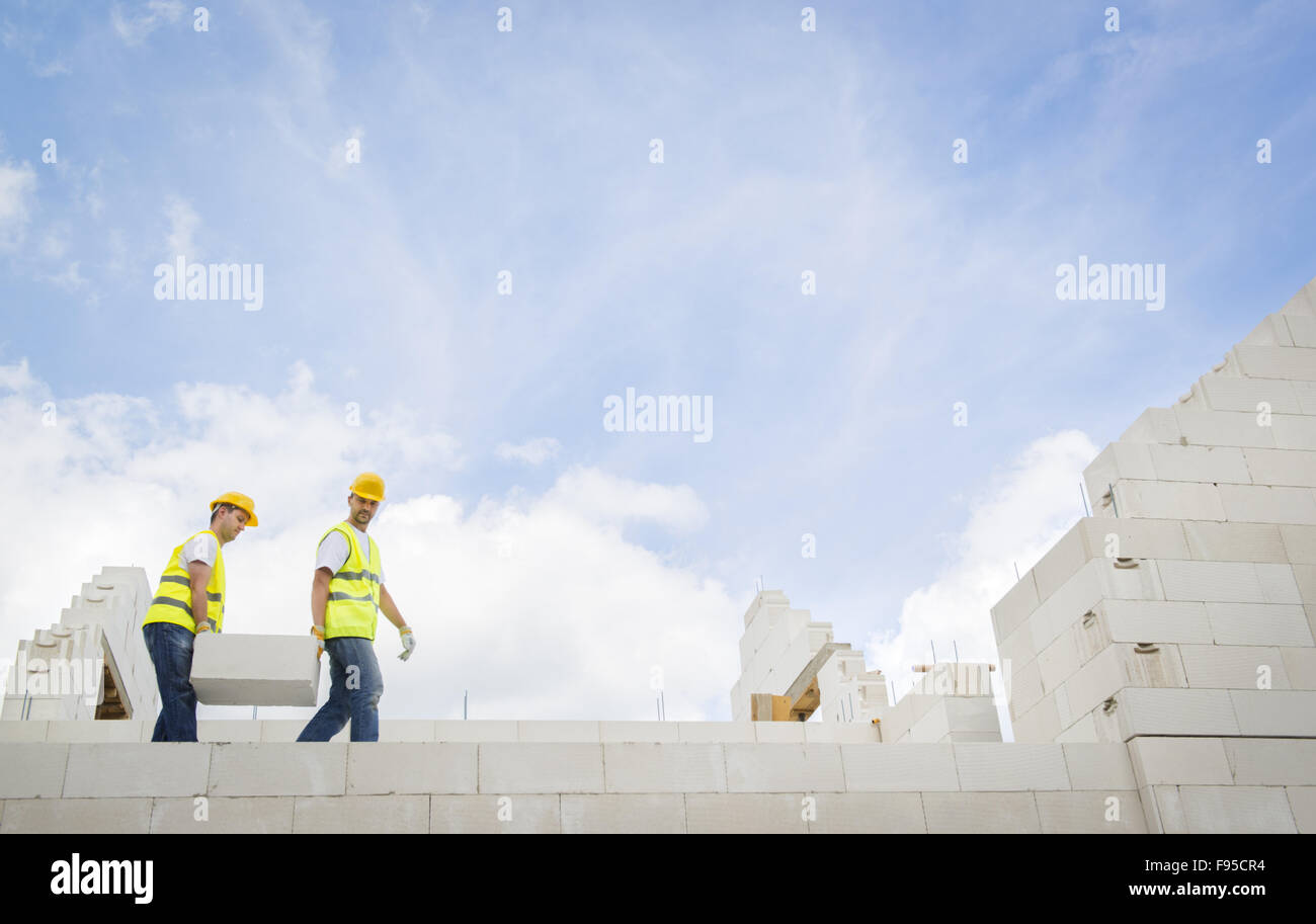 Construction Contractors building a big new home Stock Photo - Alamy