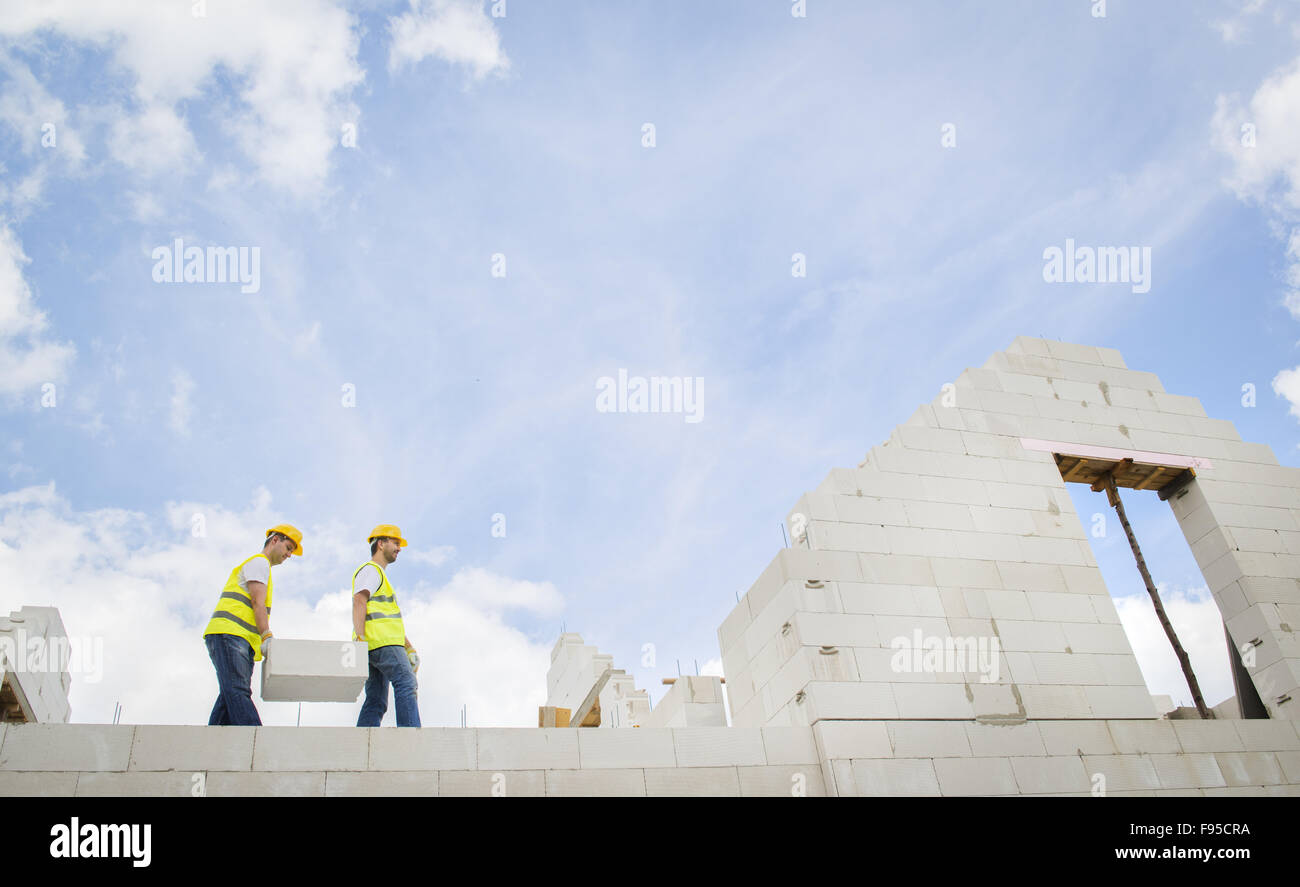 Construction Contractors building a big new home Stock Photo - Alamy