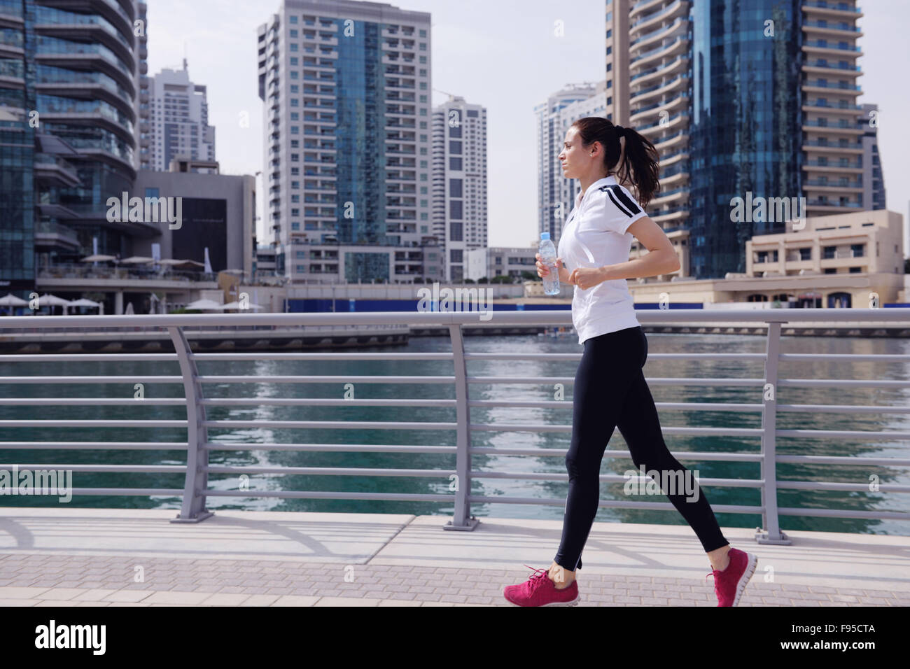 Running in city park. Woman runner outside jogging at morning with ...