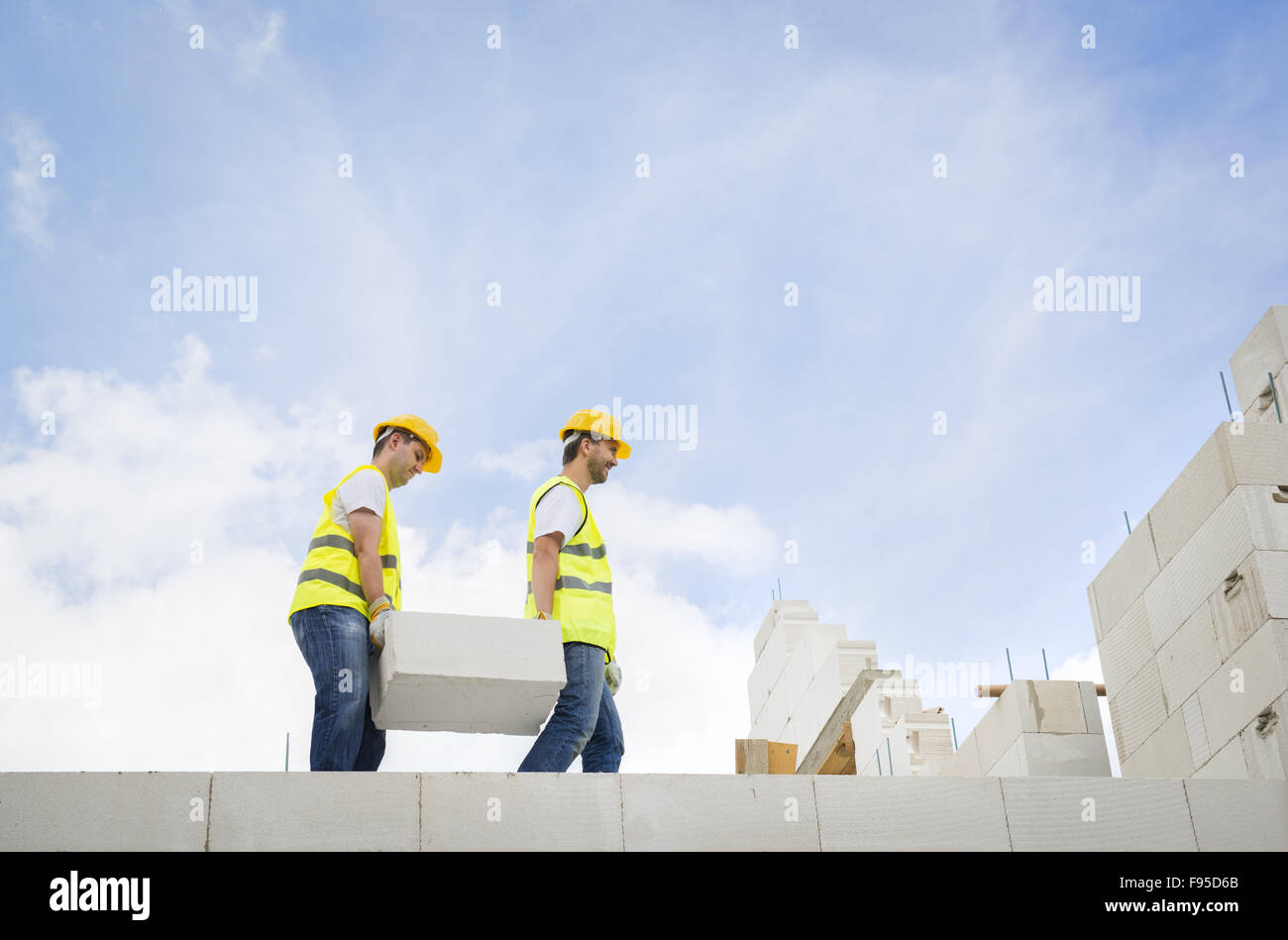 Construction Contractors building a big new home Stock Photo - Alamy