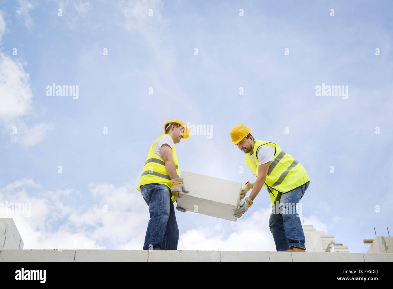 Construction Contractors building a big new home Stock Photo - Alamy