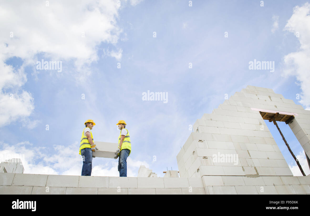 Construction Contractors building a big new home Stock Photo - Alamy