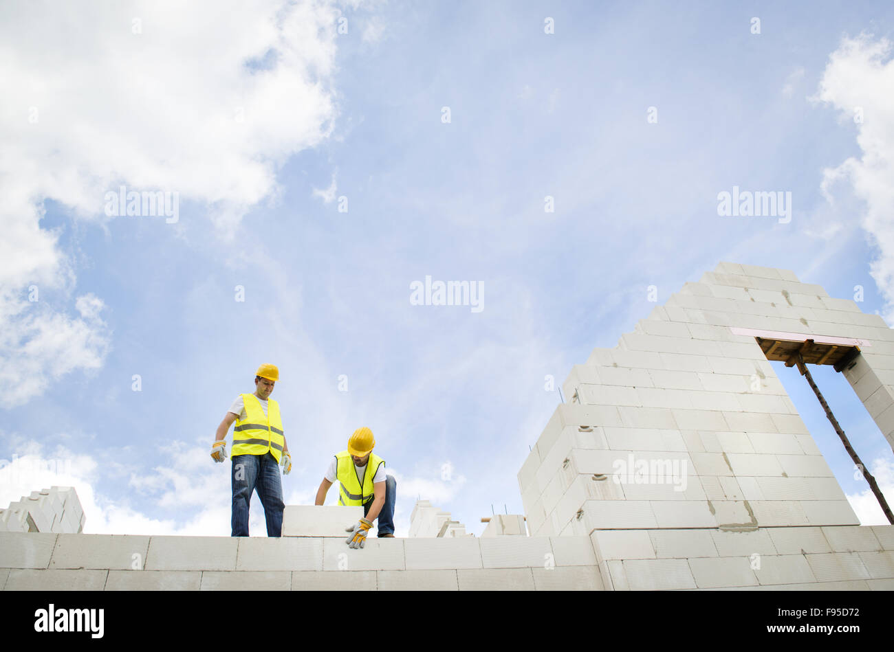 Construction Contractors building a big new home Stock Photo - Alamy