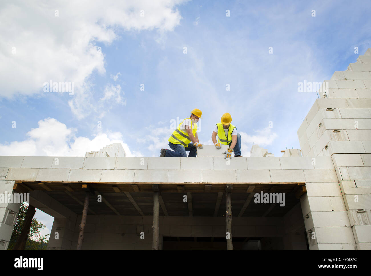 Construction Contractors building a big new home Stock Photo - Alamy