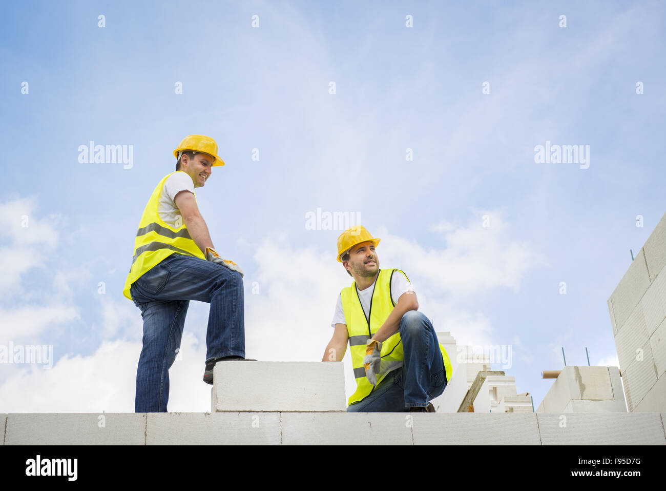 Construction Contractors building a big new home Stock Photo - Alamy