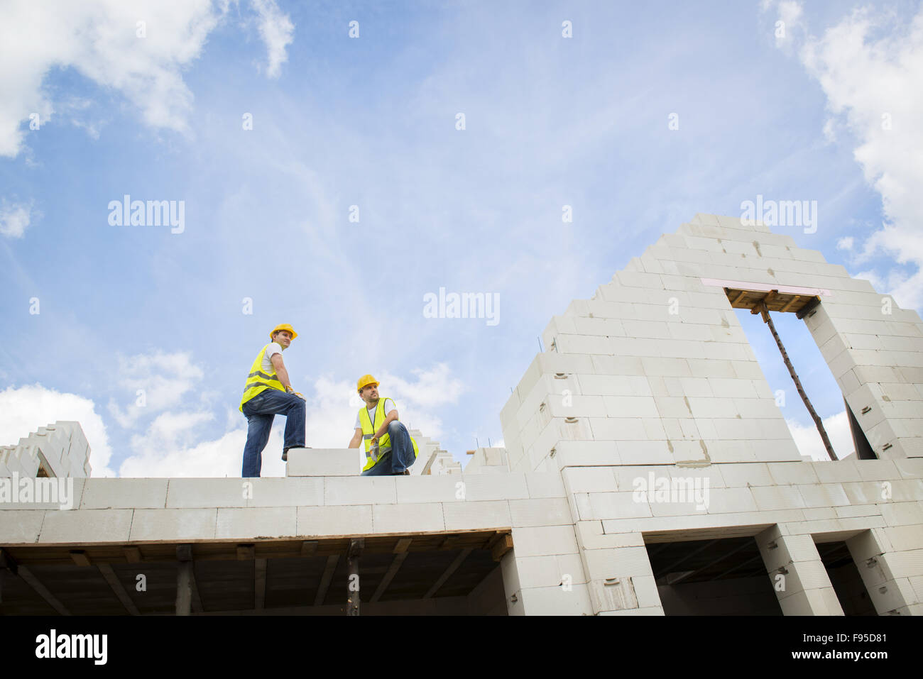 Construction Contractors building a big new home Stock Photo - Alamy