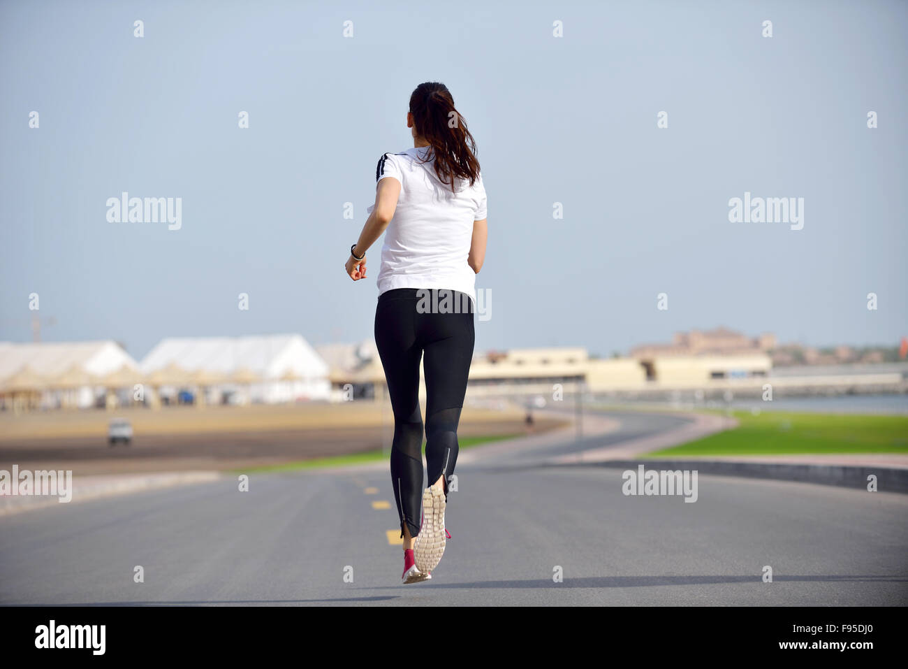 Running in city park. Woman runner outside jogging at morning with ...