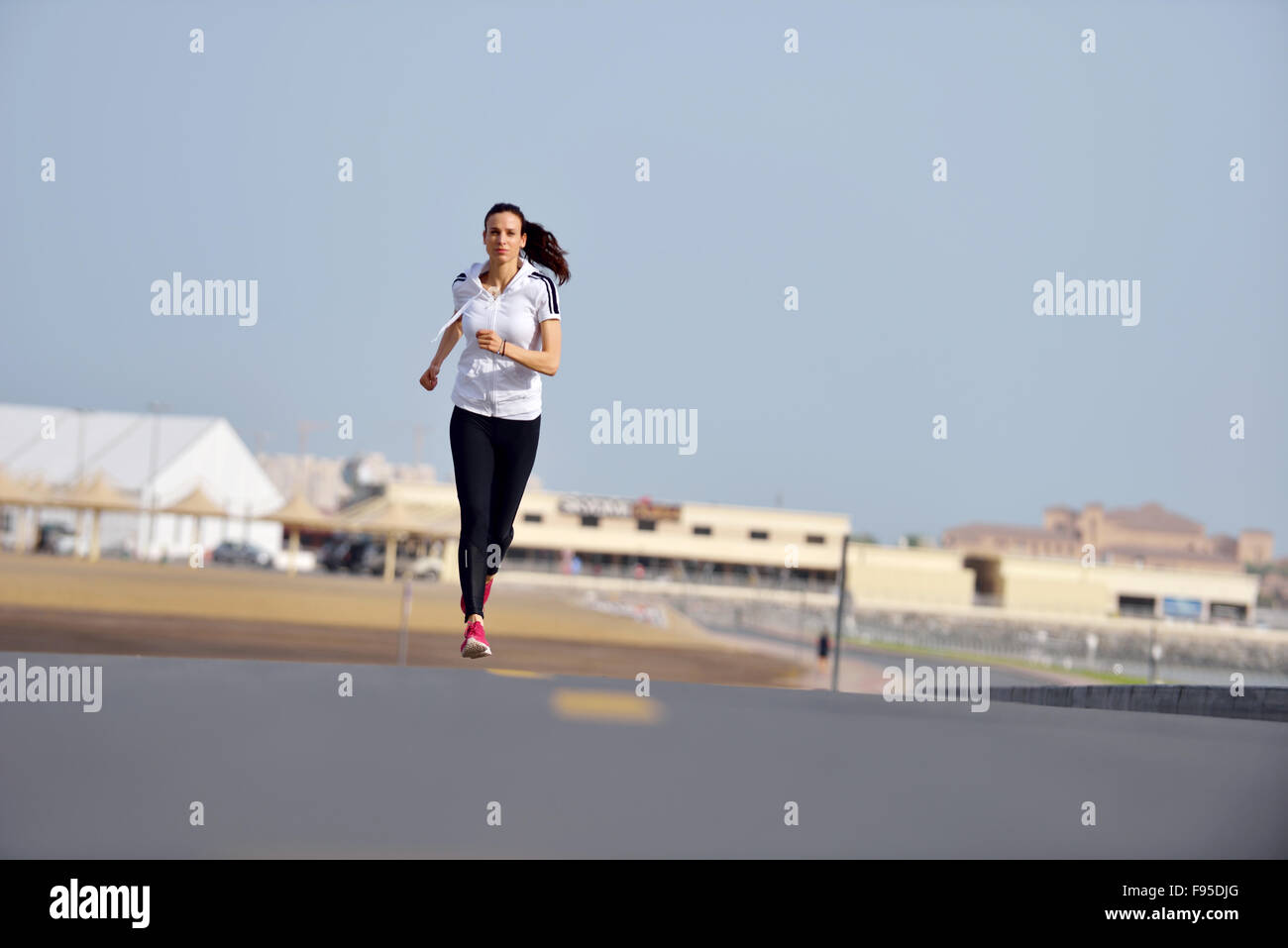 Running in city park. Woman runner outside jogging at morning with ...