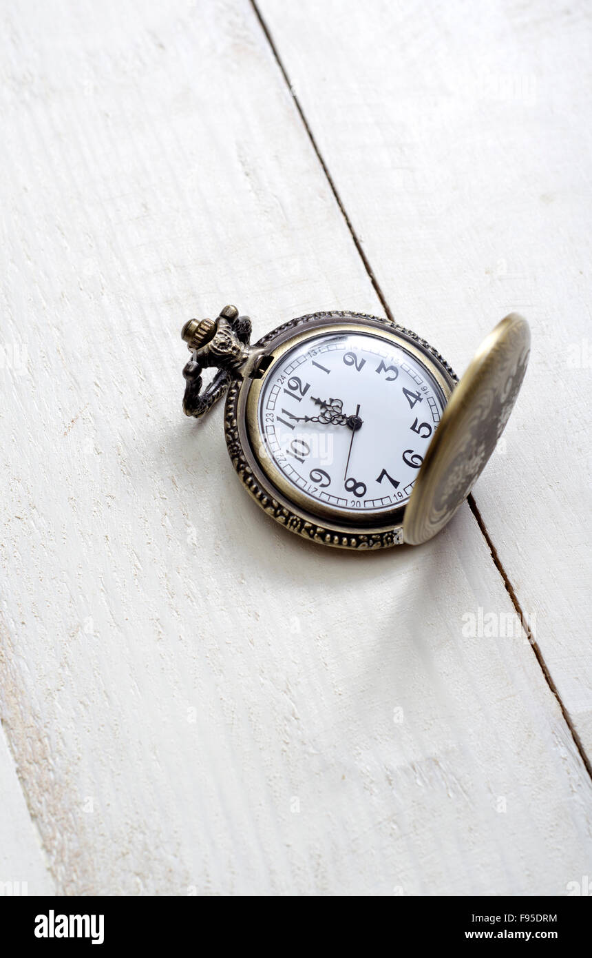 antique pocket watch with chain against rustic aged wooden background ...