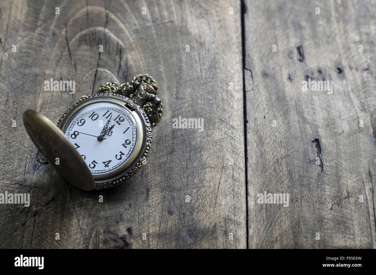 antique pocket watch with chain against rustic aged wooden background ...