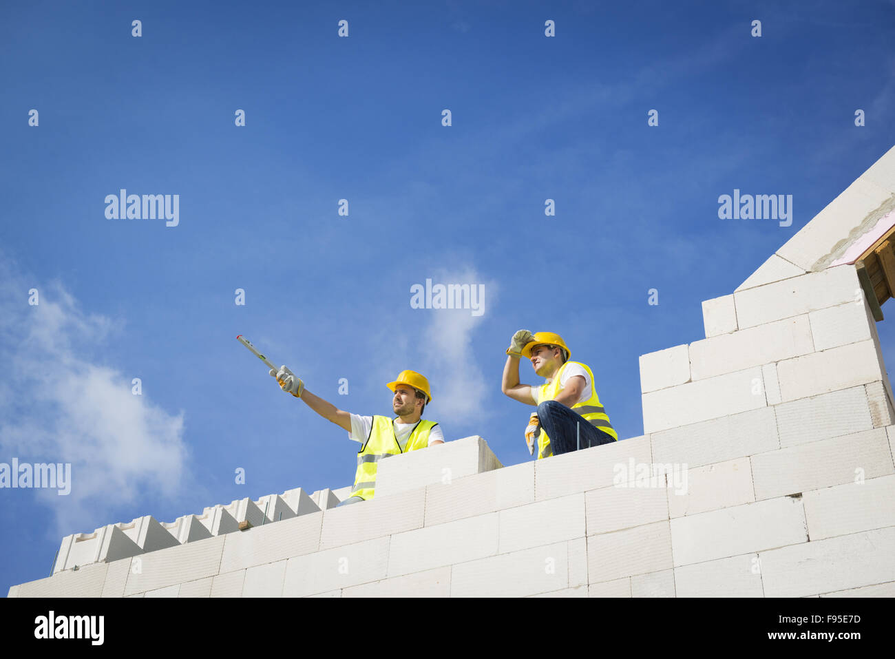Builders are working on the top of house construction Stock Photo - Alamy
