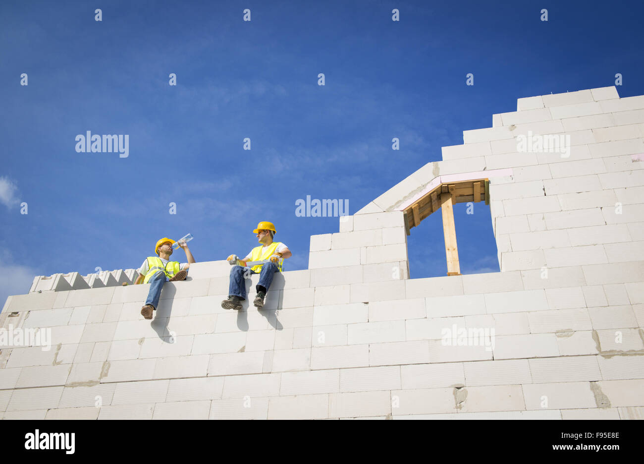 Builders are working on the top of house construction Stock Photo - Alamy