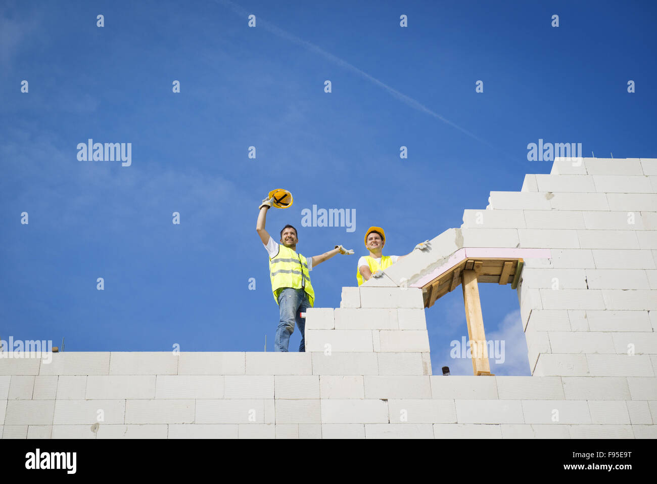Builders are working on the top of house construction Stock Photo - Alamy